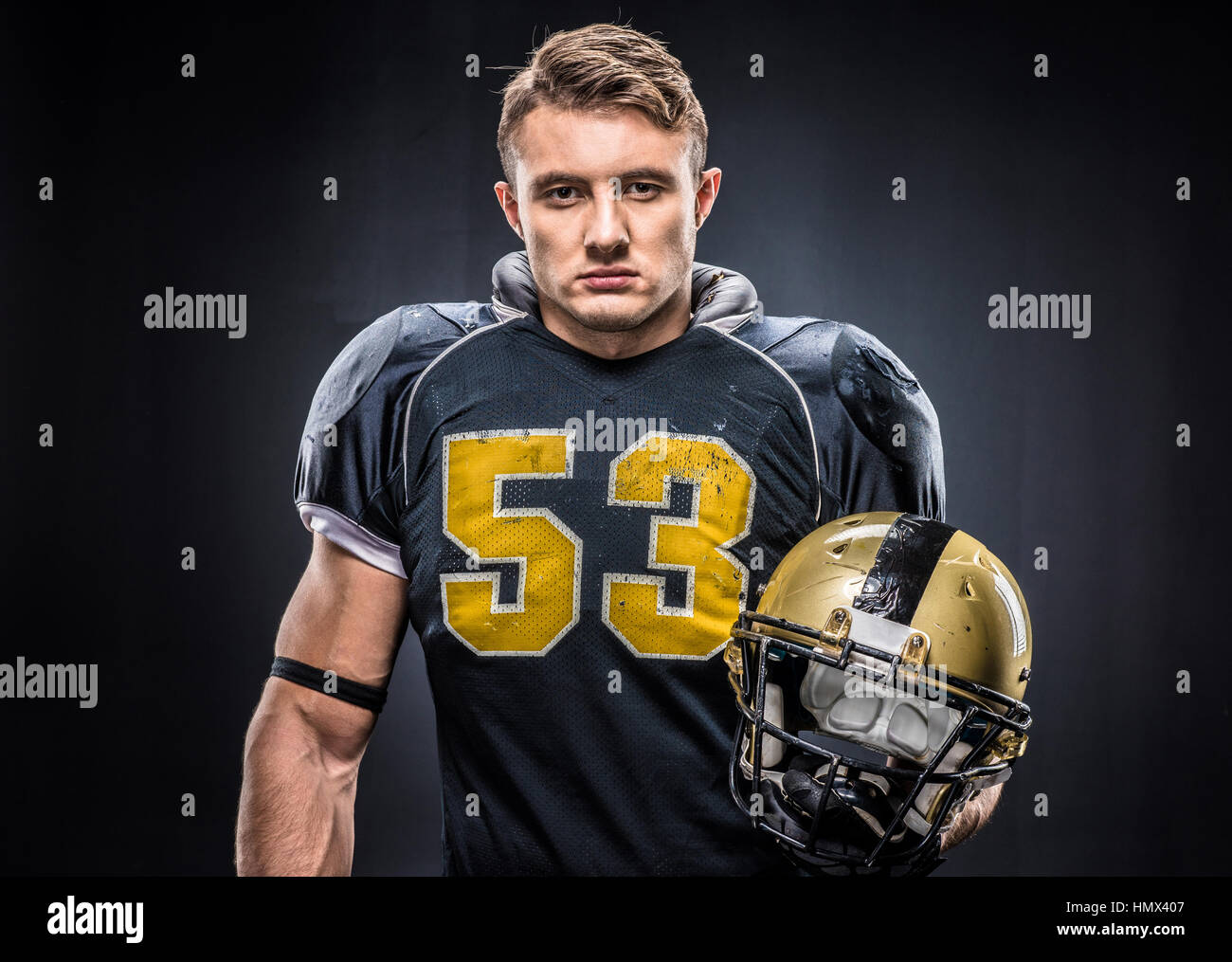 American football player holding helmet Stock Photo - Alamy