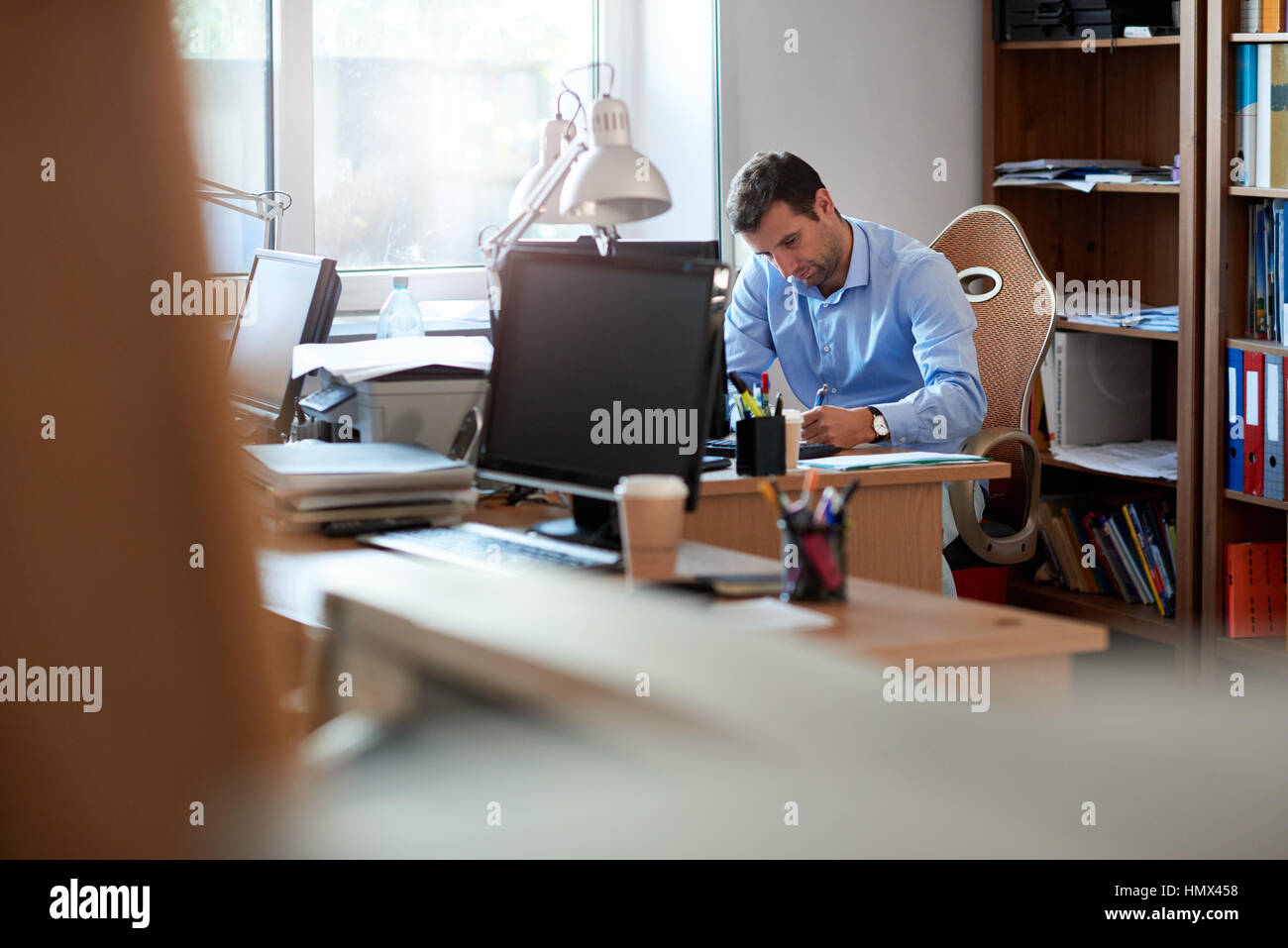 Businessman hard at work in an office Stock Photo - Alamy