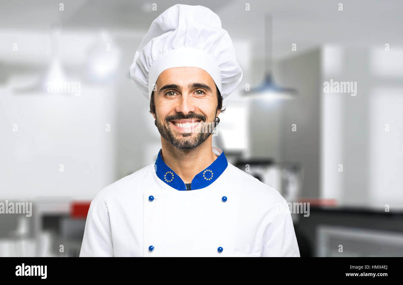 Smiling chef in his kitchen Stock Photo - Alamy