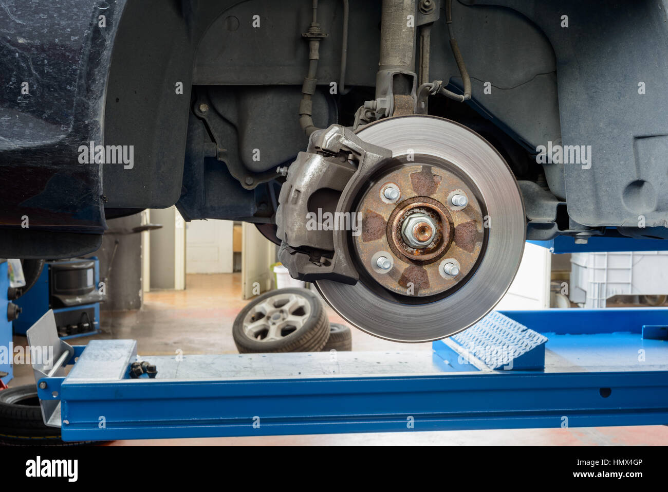 A car ready for fix on a workshop bridge, brakes are visible Stock ...
