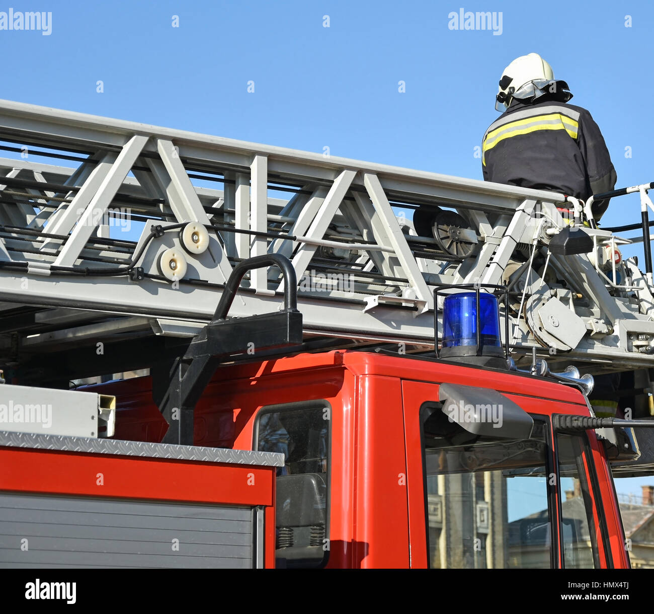 Firefighter works on the top of a fire truck Stock Photo - Alamy