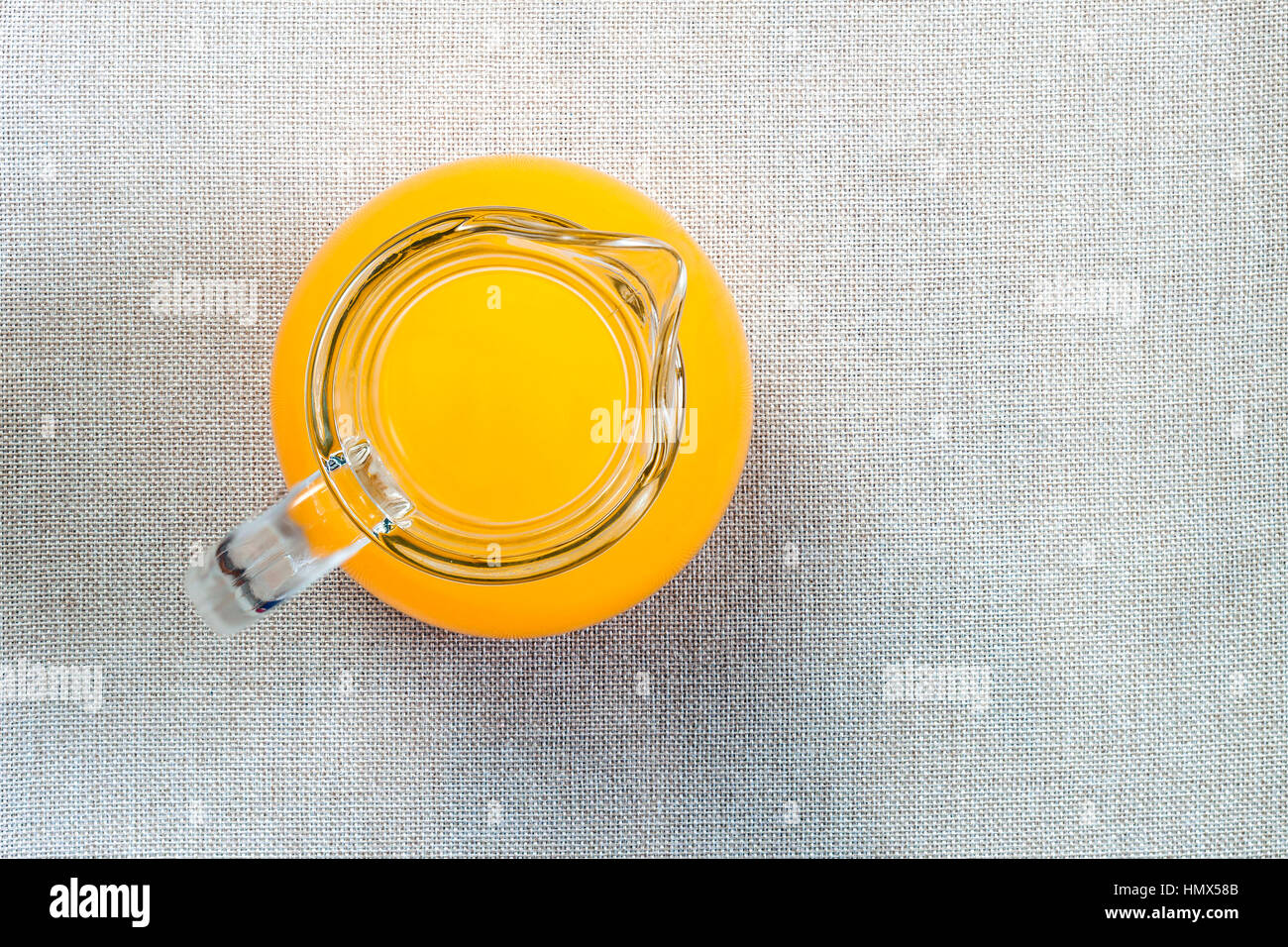 Glass of orange juice from above, top view on burlap sackcloth ...
