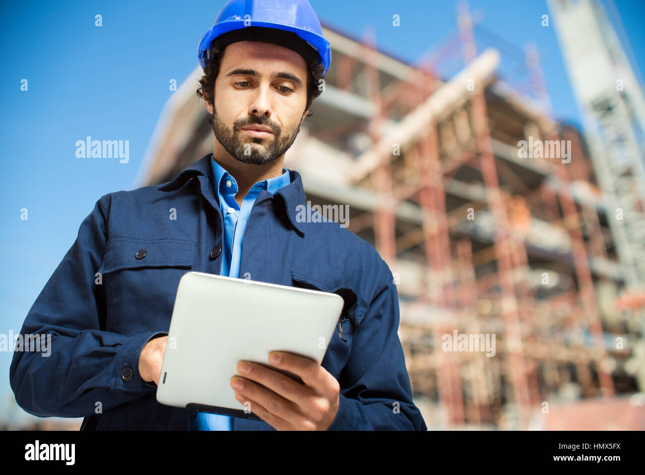 Construction specialist using a tablet computer Stock Photo - Alamy