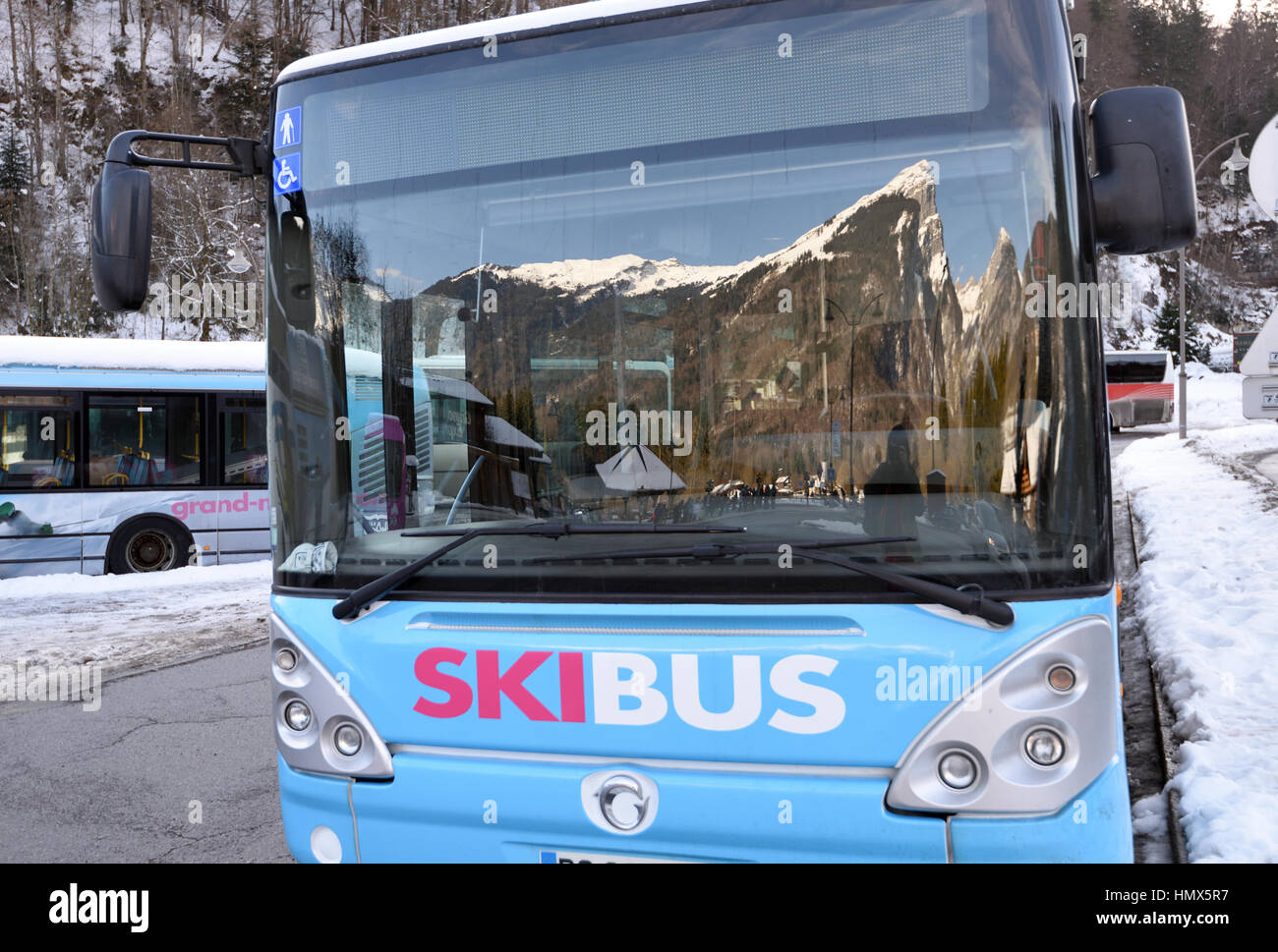 Snowy mountains of the ski resort reflected in the windscreen of a ski ...