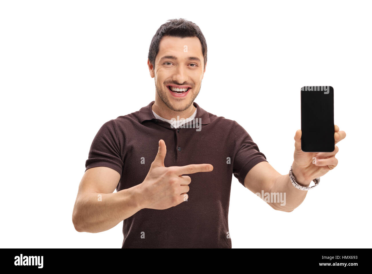 Happy man showing a phone and pointing isolated on white background ...