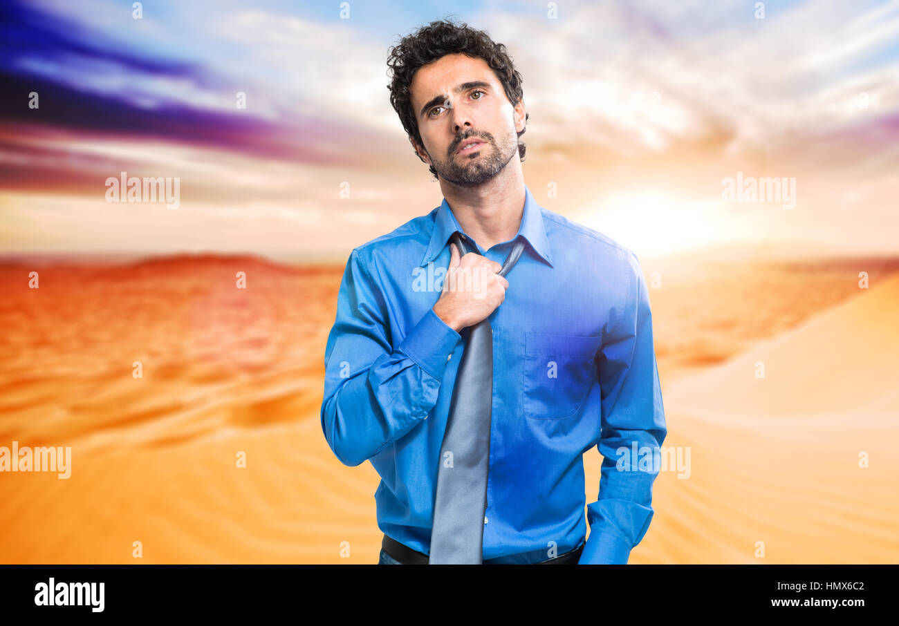 Fired businessman sweating in the desert Stock Photo - Alamy