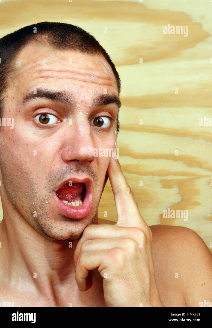 The young man in surprise at the sight of infections of the skin on the ...
