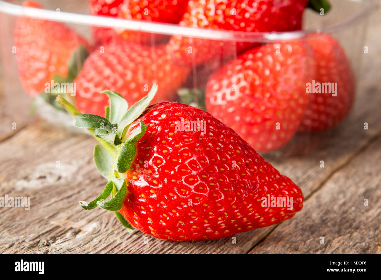 Red strawberry with box full of strawberries in a background Stock ...
