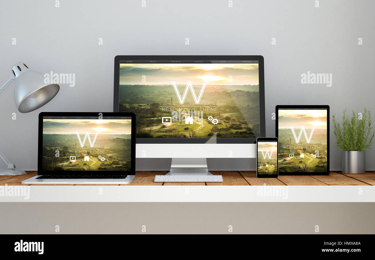 A computer, laptop, smartphone and tablet on a desktop workspace with ...