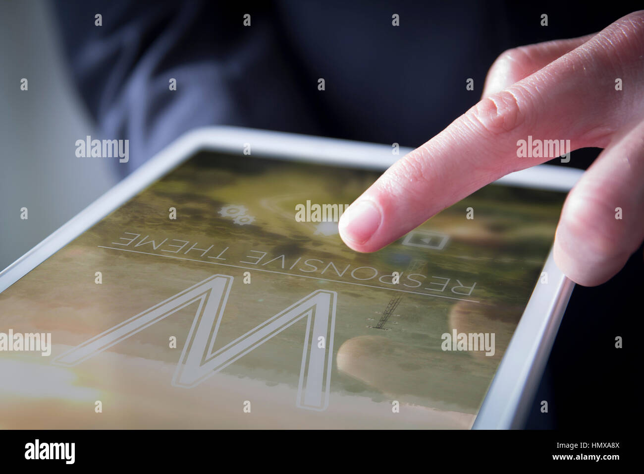 finger touches digital tablet showing responsive website template on ...