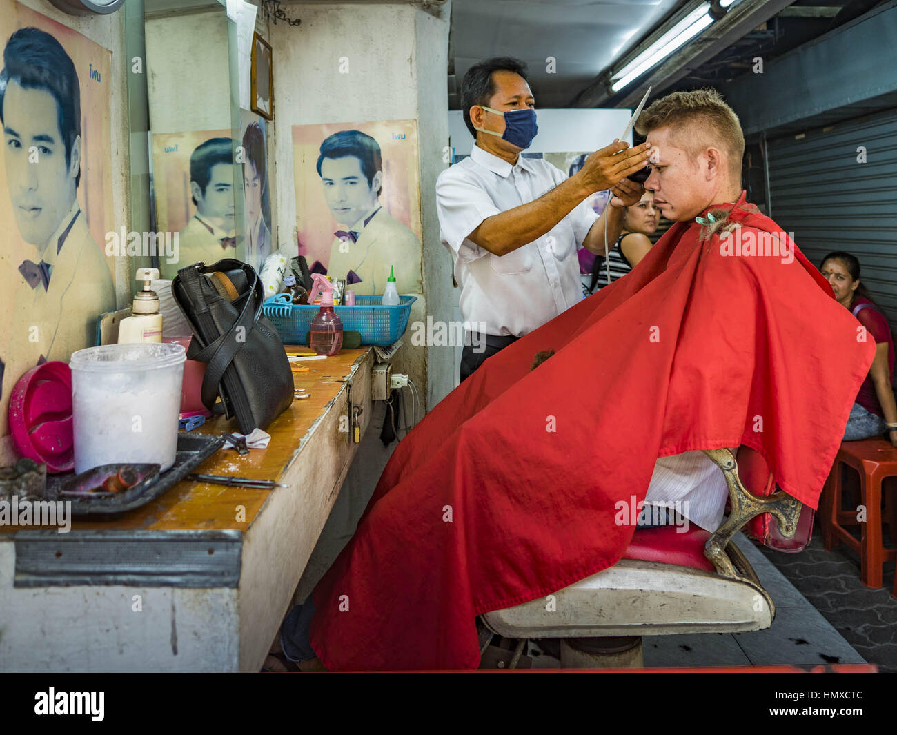 Bangkok, Bangkok, Thailand. 6th Feb, 2017. A barber cuts a customer's ...