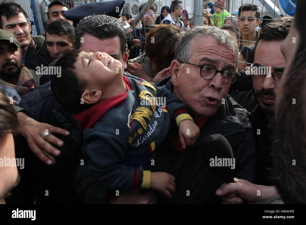 Child crying as handed to another hi-res stock photography and images ...