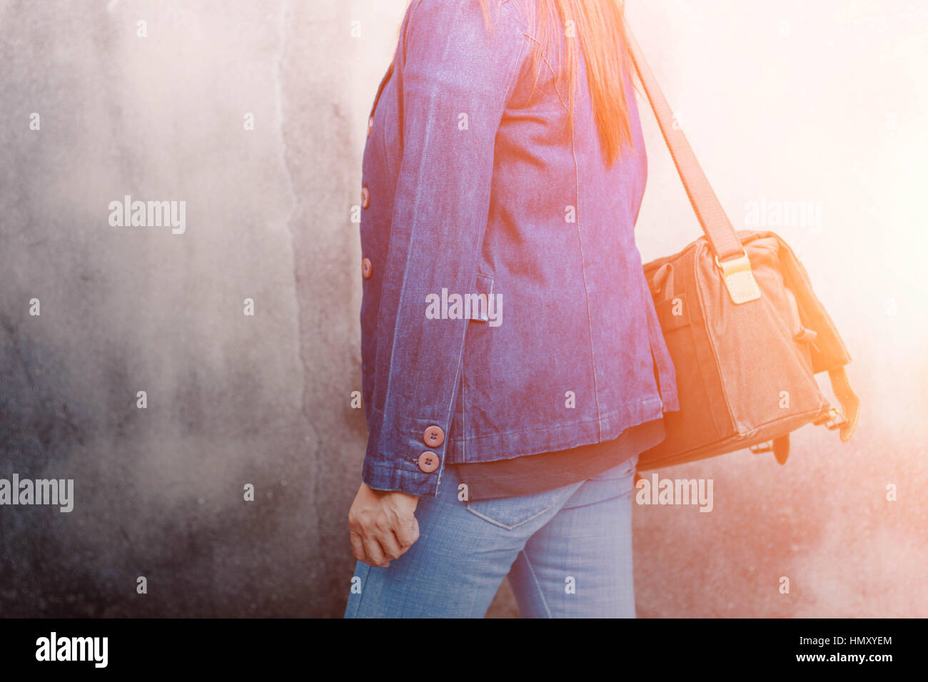 Women's fashion of denim jacket and backpack Stock Photo - Alamy