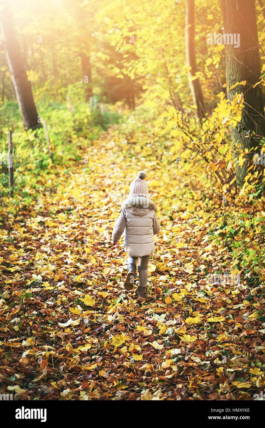 A little child running away to forest. Vertical outdoors shot Stock ...