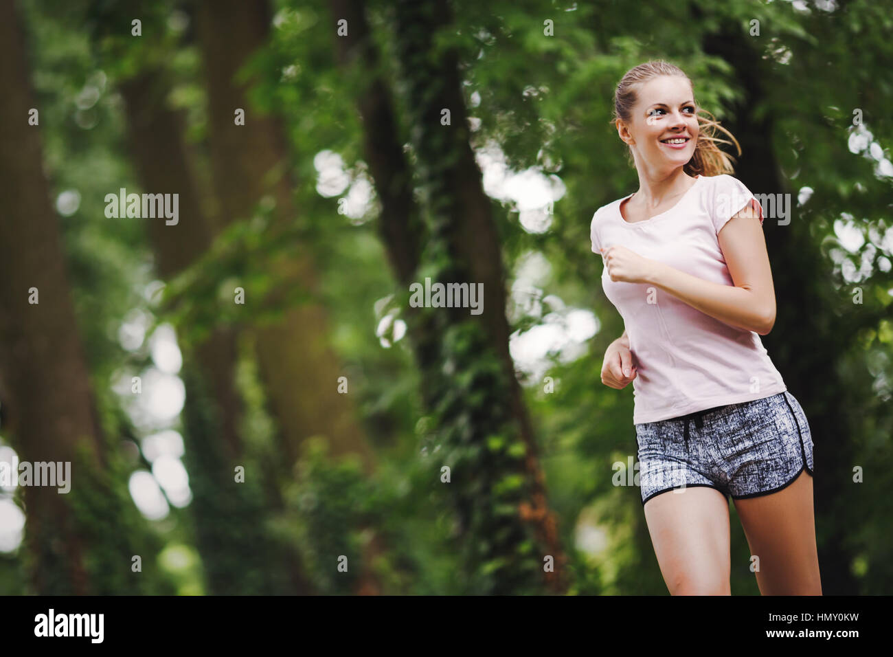 Beautiful jogging woman in nature staying fit and energetic Stock Photo ...