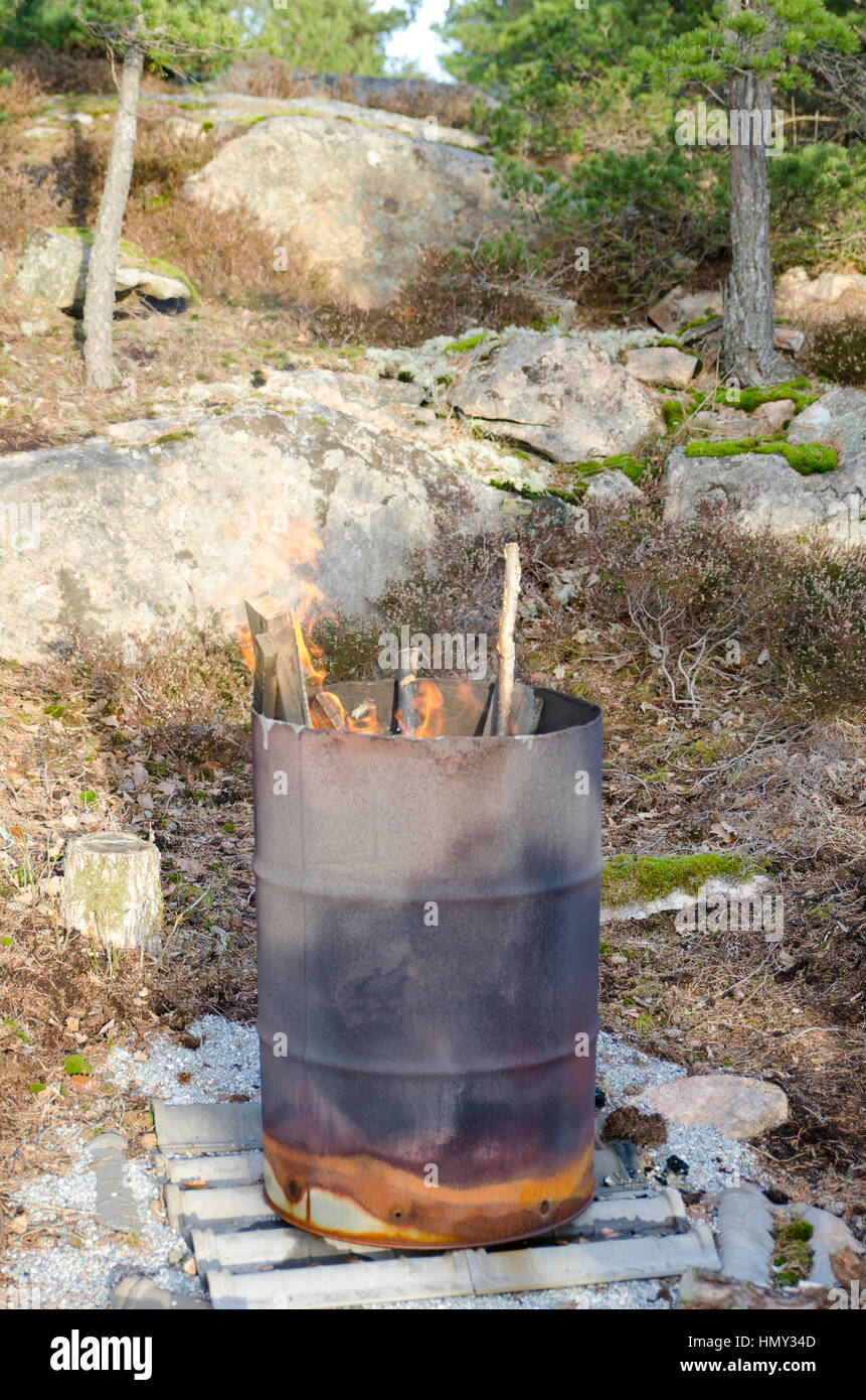 Fire in one old rusty barell standing in the nature Stock Photo - Alamy