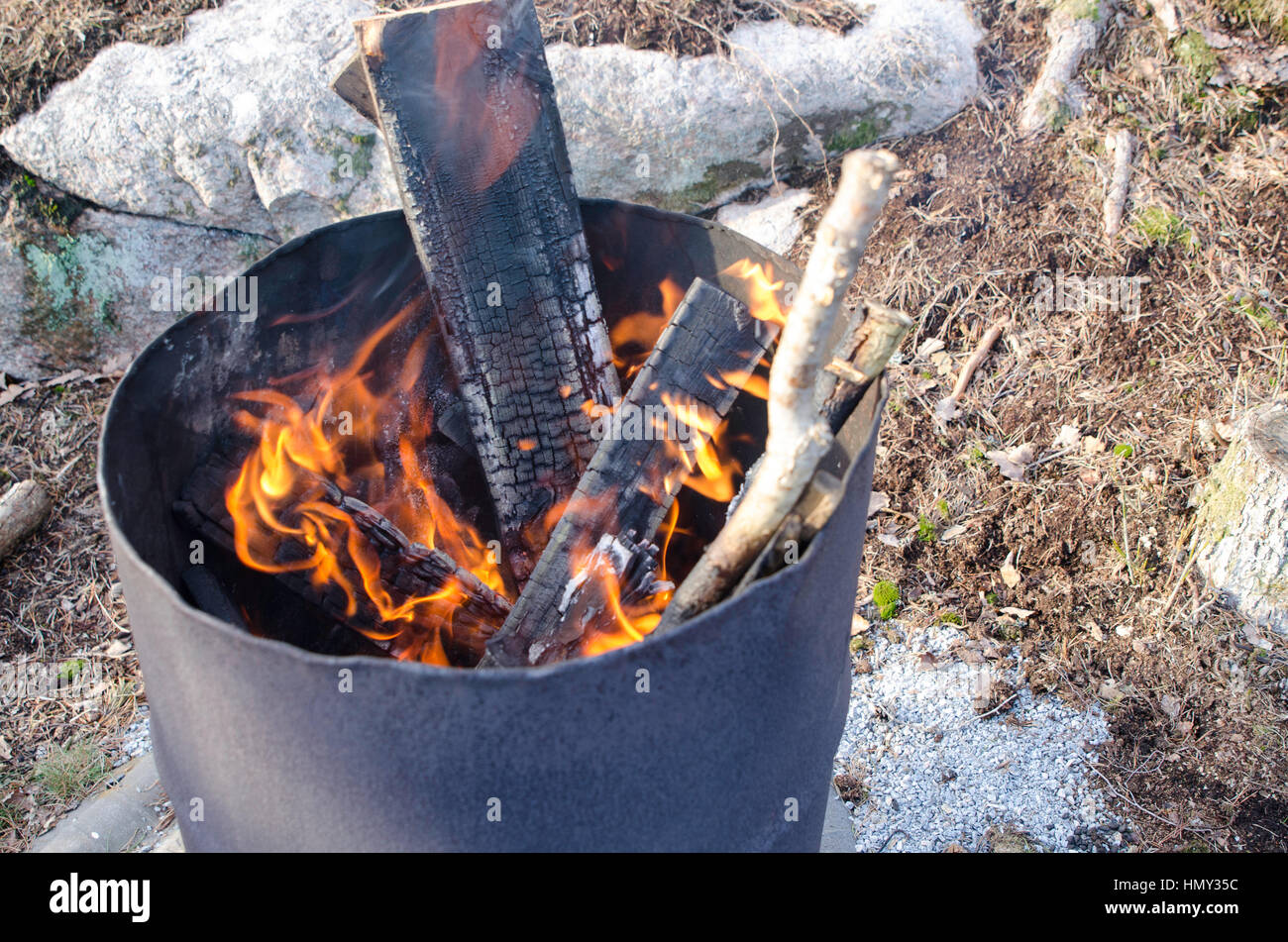Fire in one old rusty barell standing in the nature Stock Photo - Alamy