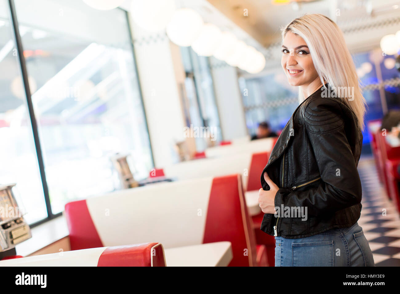 Young woman in diner Stock Photo - Alamy