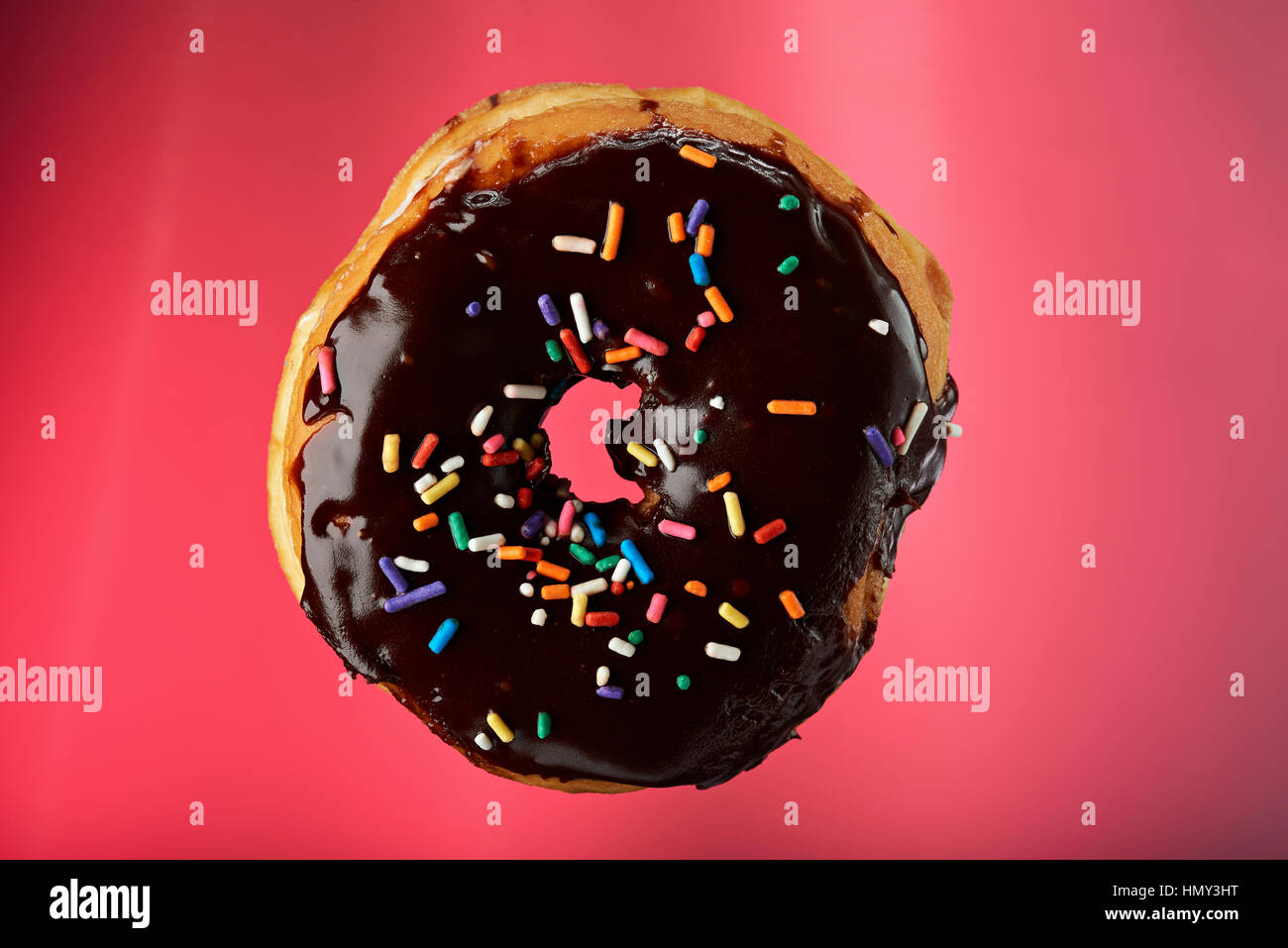 one chocolate donut view from top on red Stock Photo - Alamy