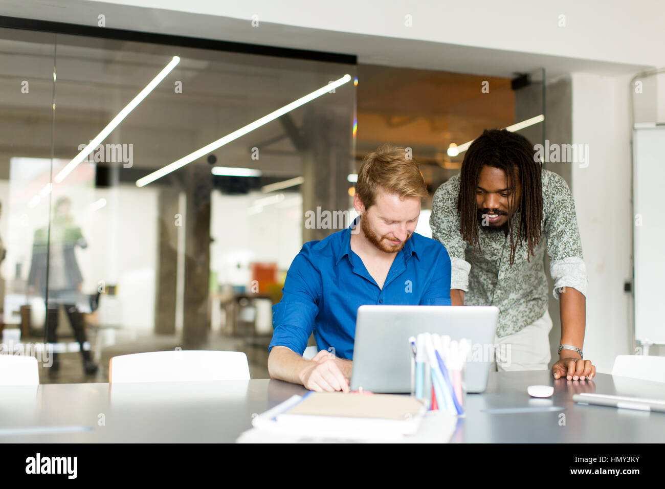 Multiracial male team working in office Stock Photo - Alamy