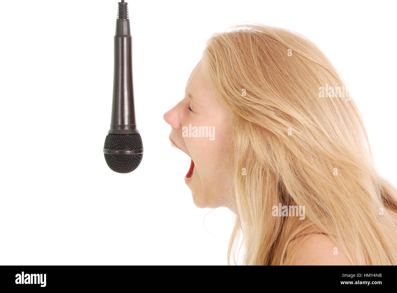 Happy young beautiful girl singing with microphone isolated on white ...