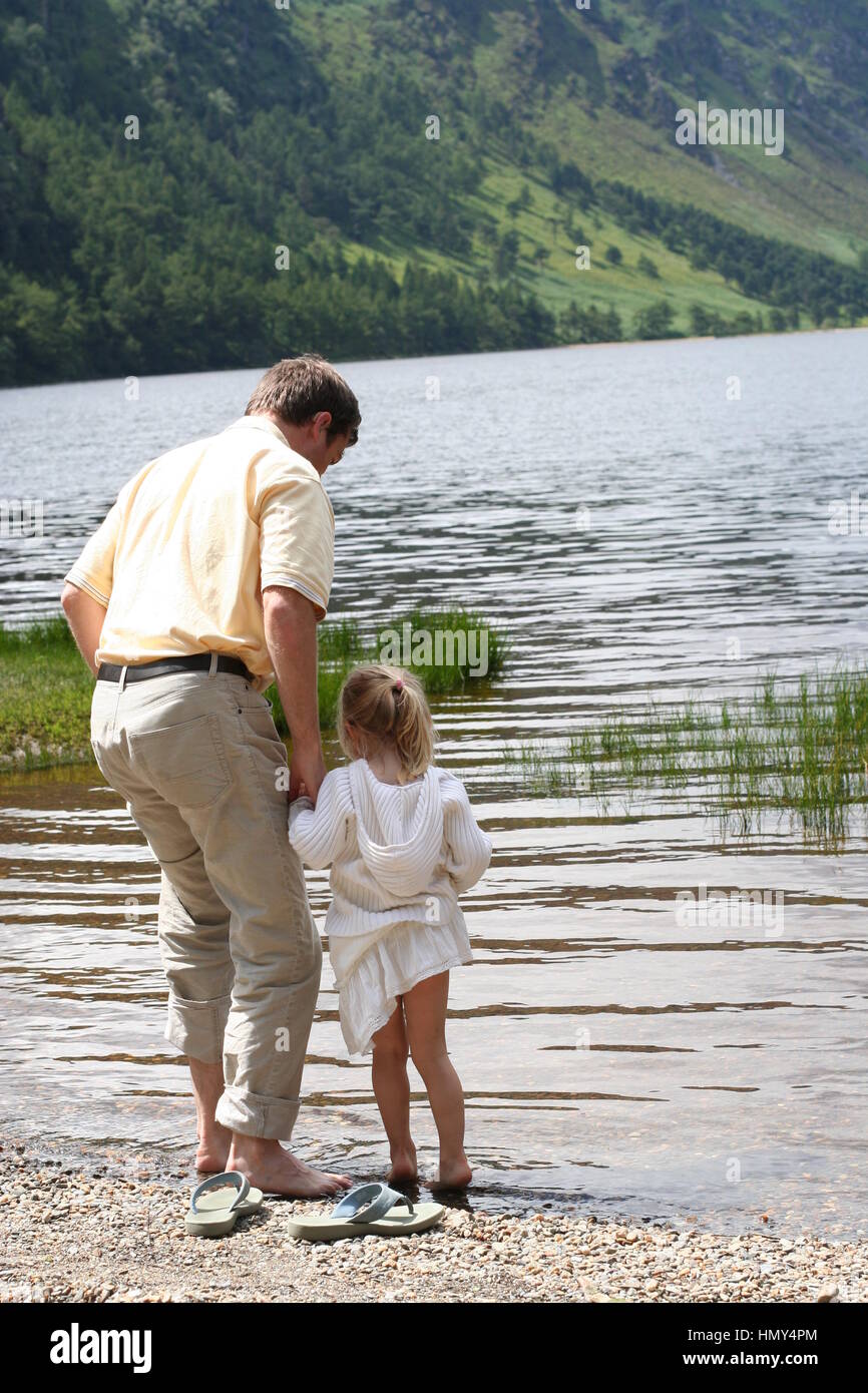 Father and Daughter paddling in the stream at the upper lake in ...