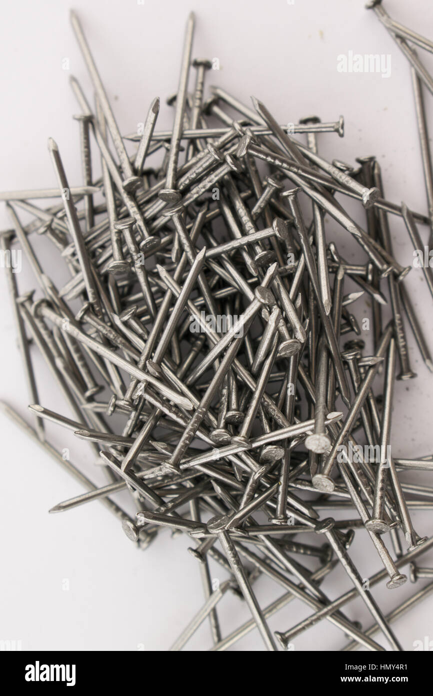 Steel nails on white background Stock Photo - Alamy