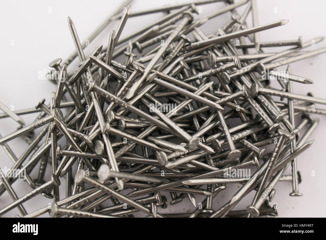 Steel nails on white background Stock Photo - Alamy