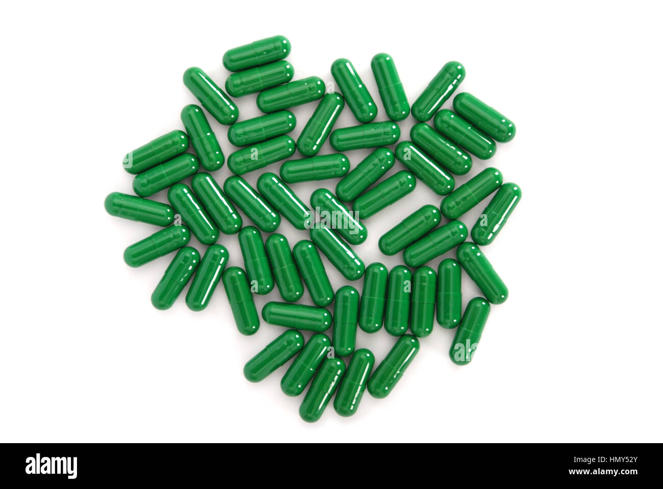 Group green capsules isolated on white background Stock Photo - Alamy