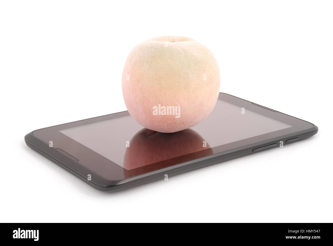 Peach on a tablet PC. Photo with clipping path Stock Photo - Alamy