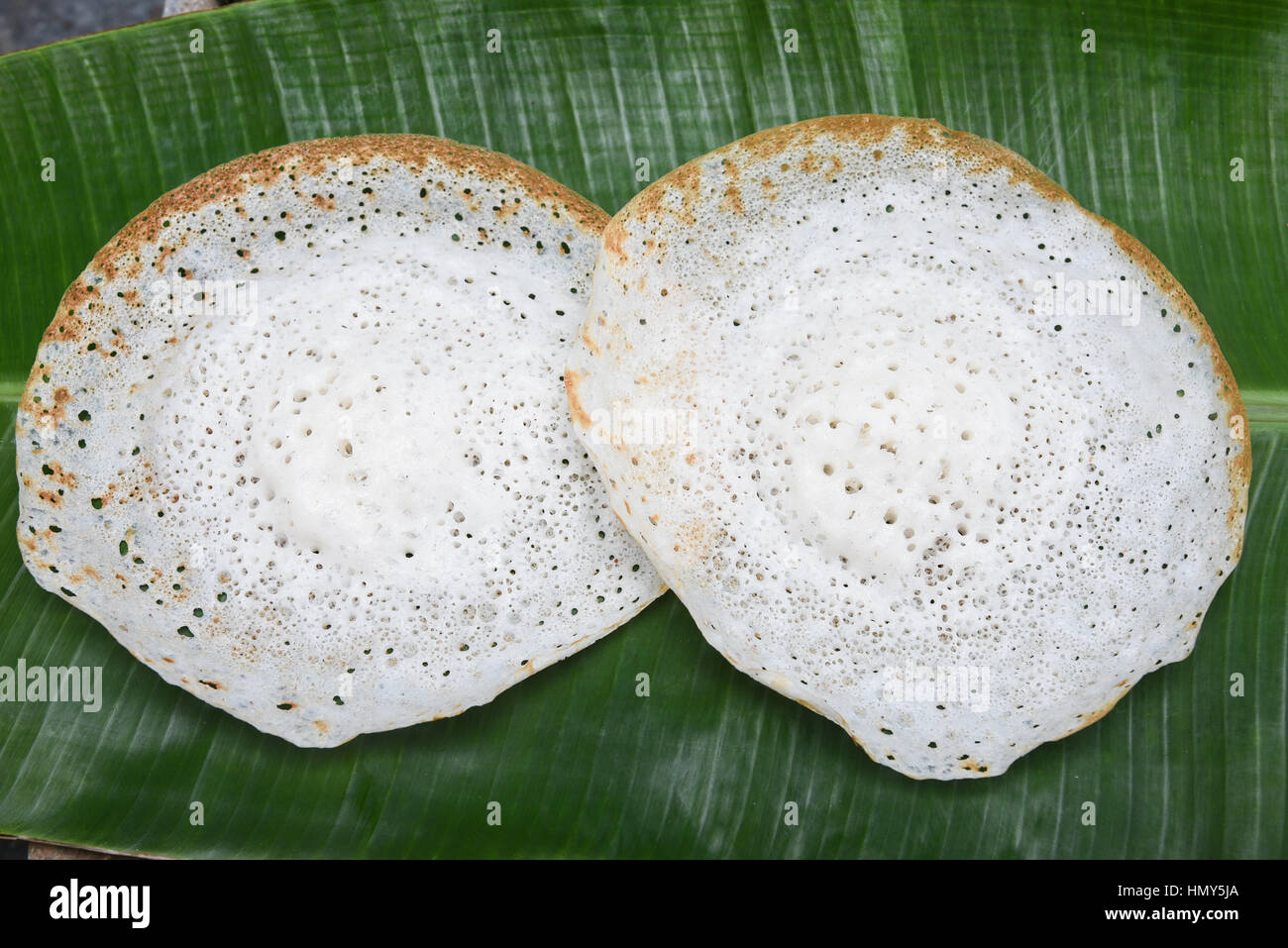 Appam with mutton/beef/meat roast curry in green banana leaf. made of ...