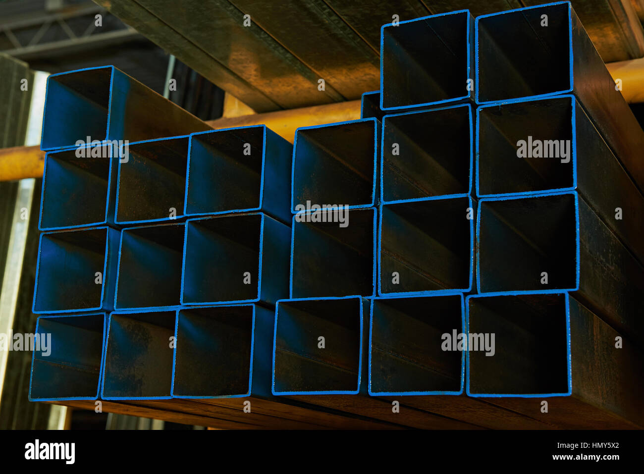 group of blue square metal tube in warehouse Stock Photo - Alamy