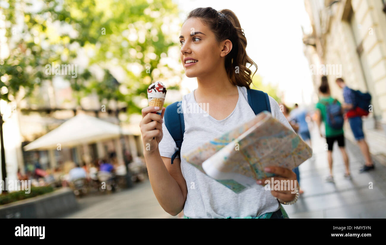 Beautiful woman eating ice cream outdoors while traveling Stock Photo ...