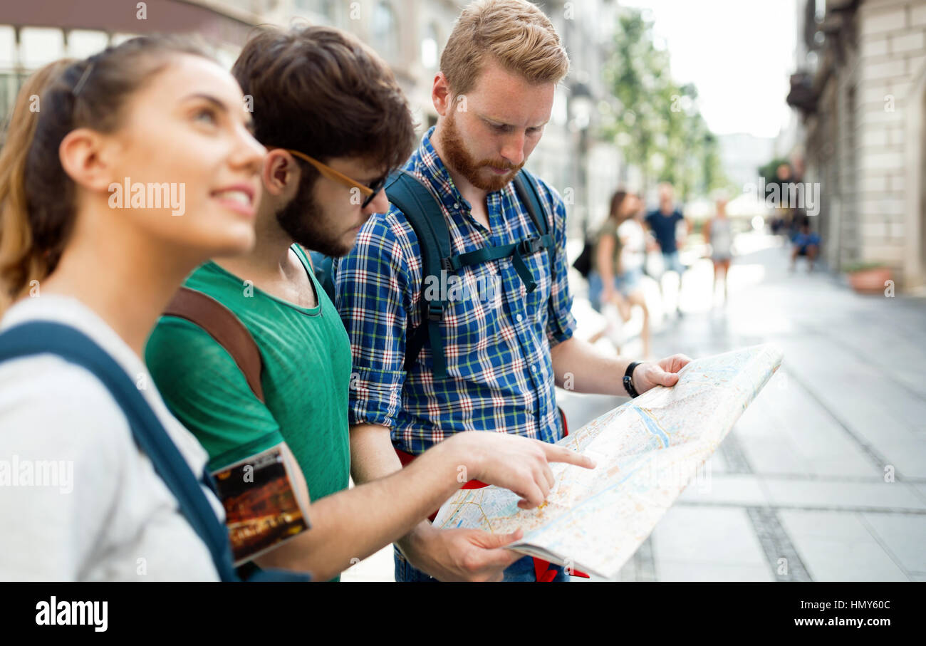 Young happy tourists holding map sightseeing in city Stock Photo - Alamy
