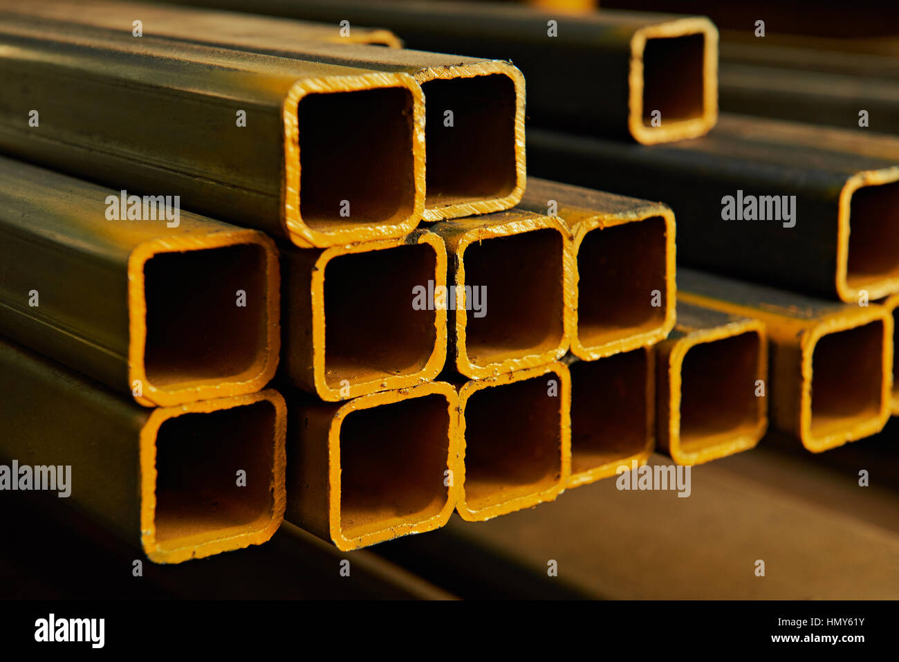 close up of yellow square metal tubes in warehouse Stock Photo - Alamy