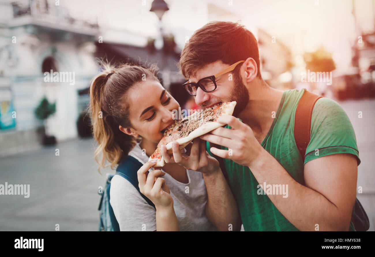 Positive happy students eating pizza on street Stock Photo - Alamy
