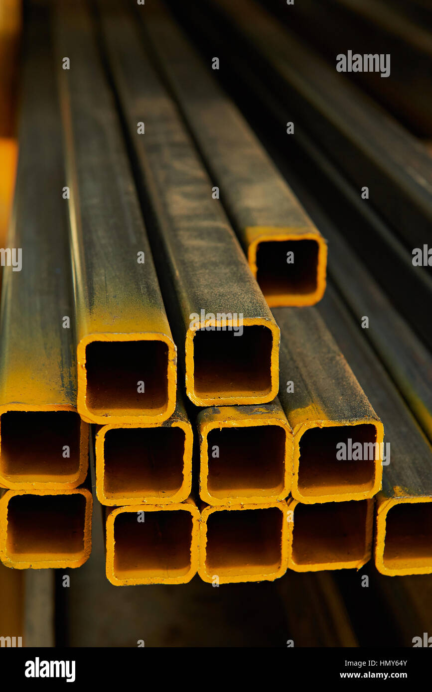 yellow metal steel profile tubes in warehouse Stock Photo - Alamy