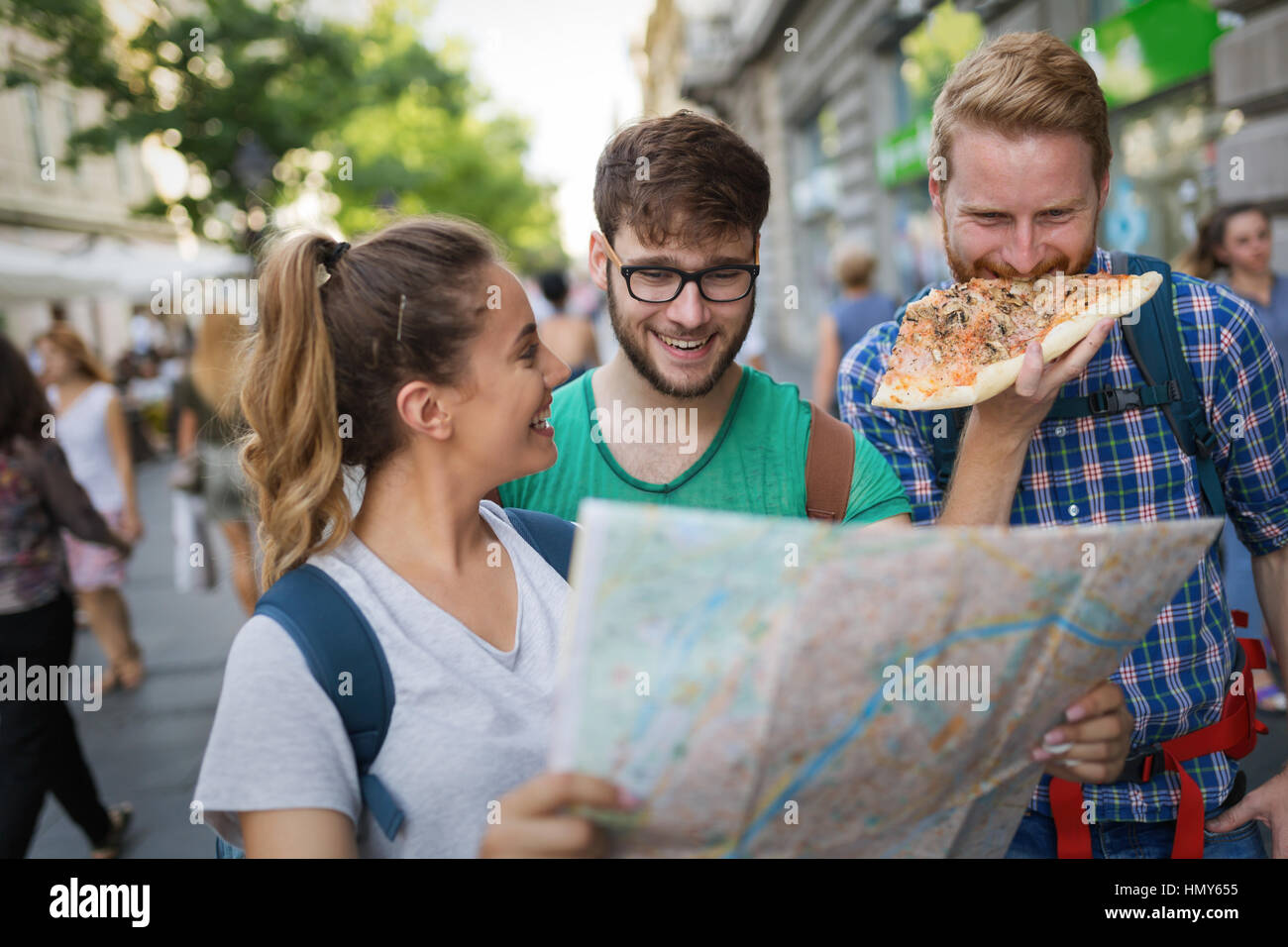 Young happy tourists holding map sightseeing in city Stock Photo - Alamy