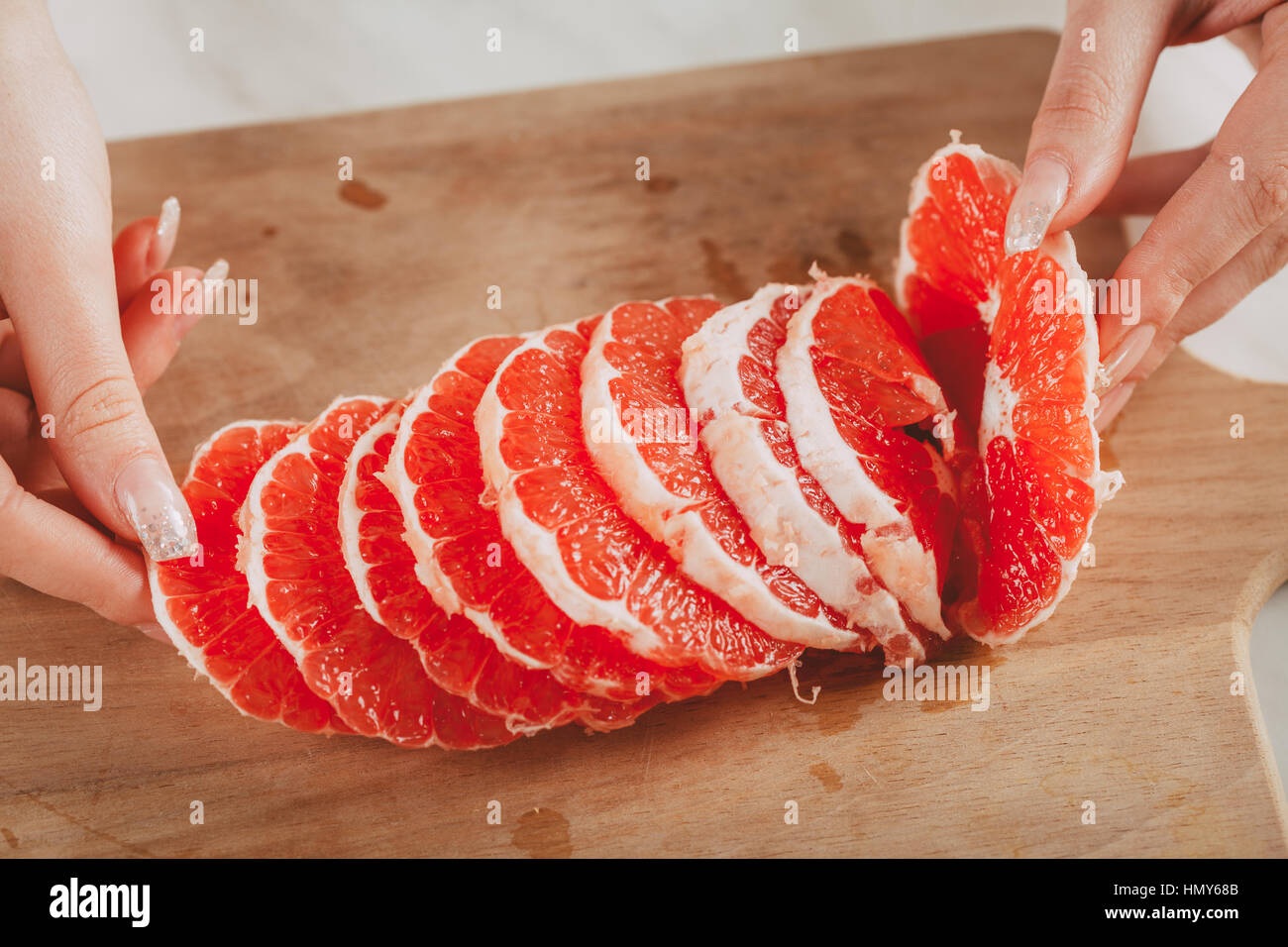 Close-up of a sliced red grapefruit on the kitchen board Stock Photo ...