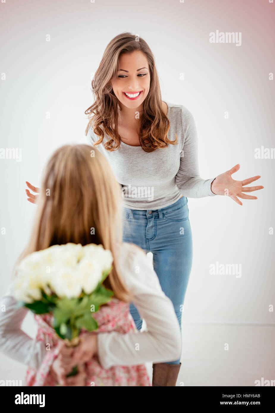 Cute daughter giving her mother Bouquet white roses for Mother's Day ...