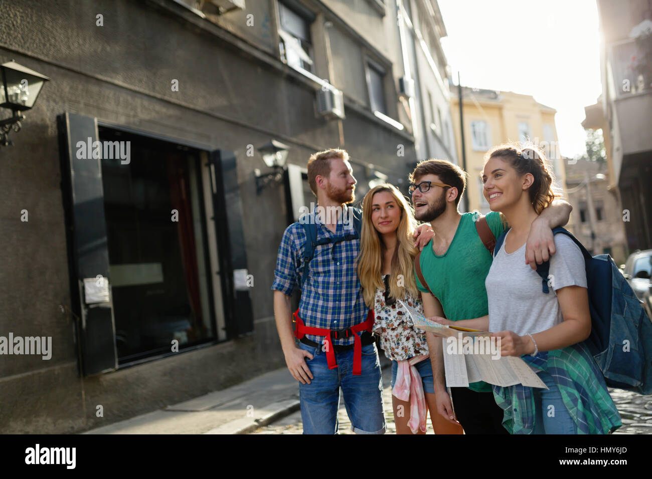 Young happy cute tourists holding map sightseeing in city Stock Photo ...