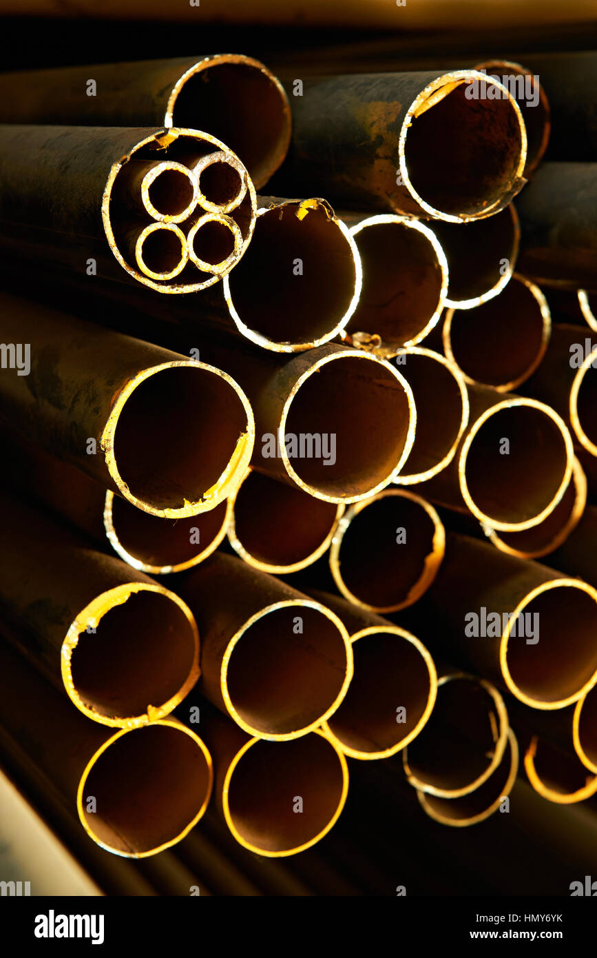 rusty yellow round steel pipes in warehouse Stock Photo - Alamy