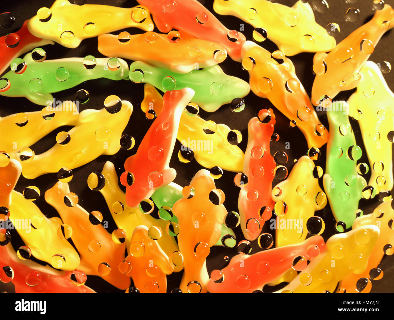 Candy colored viewed through water droplets Stock Photo - Alamy