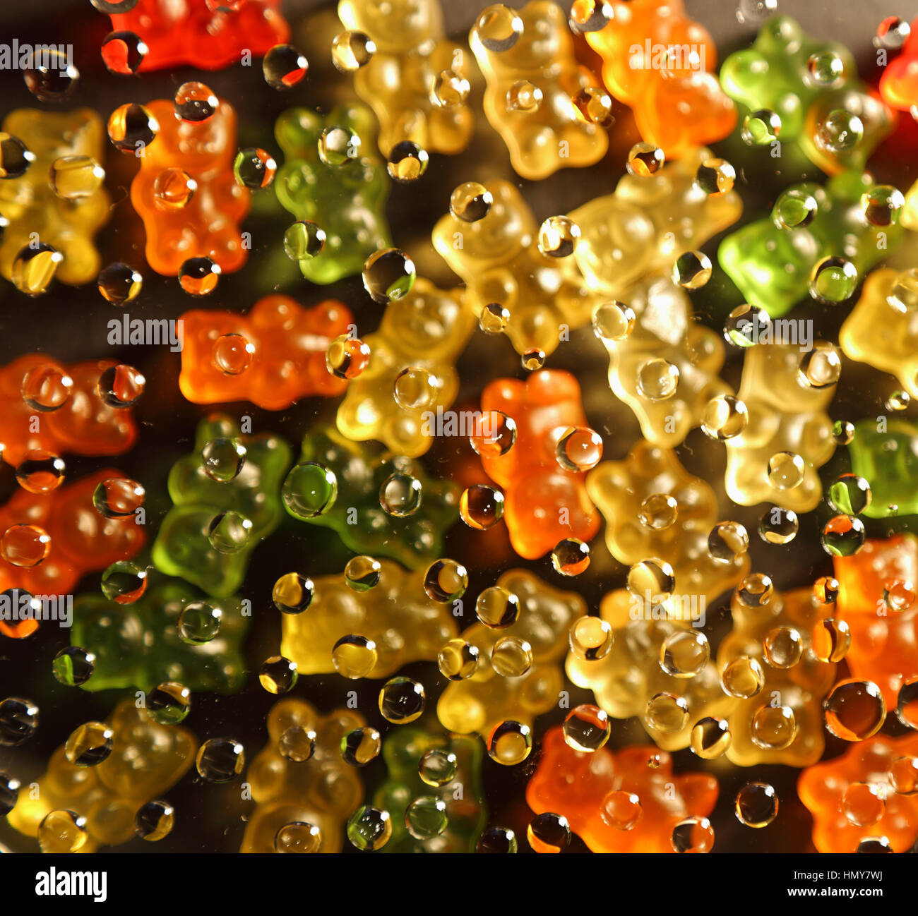 Candy colored viewed through water droplets Stock Photo - Alamy