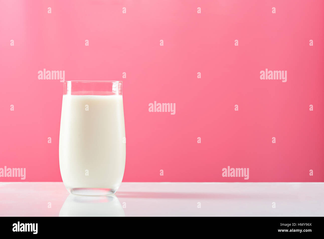 isolated glass with milk on red background Stock Photo - Alamy