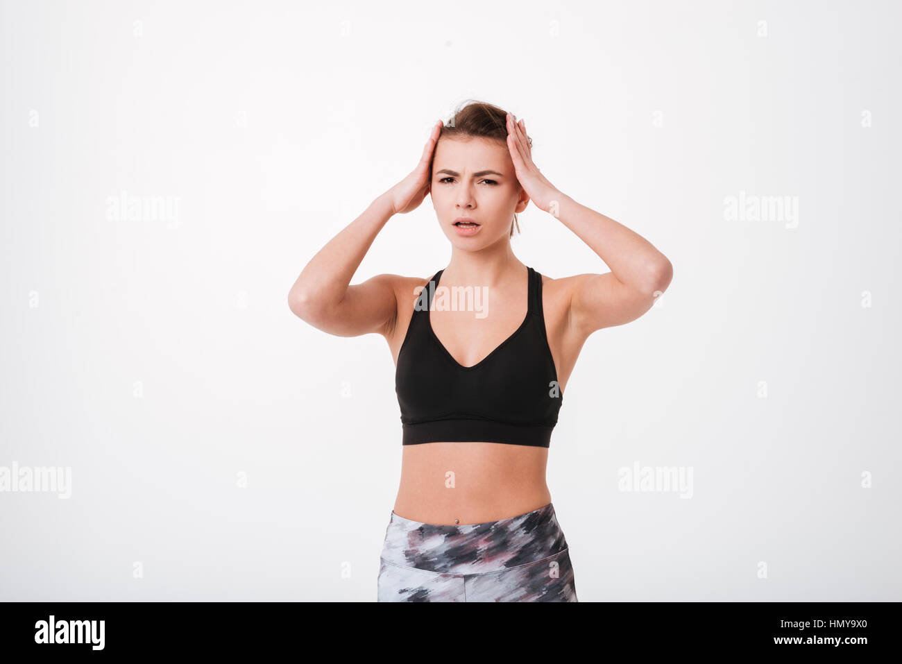 Image of confused young fitness lady standing isolated over white ...
