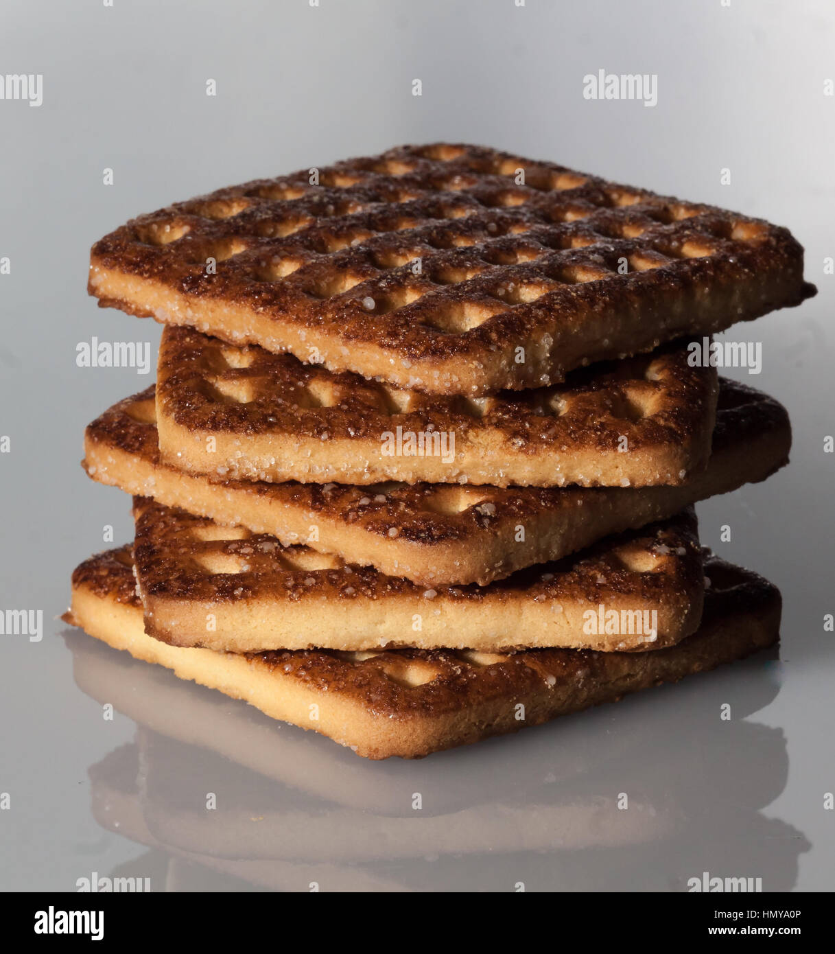 stack of square crackers with pieces and crumbs on slate gray ...