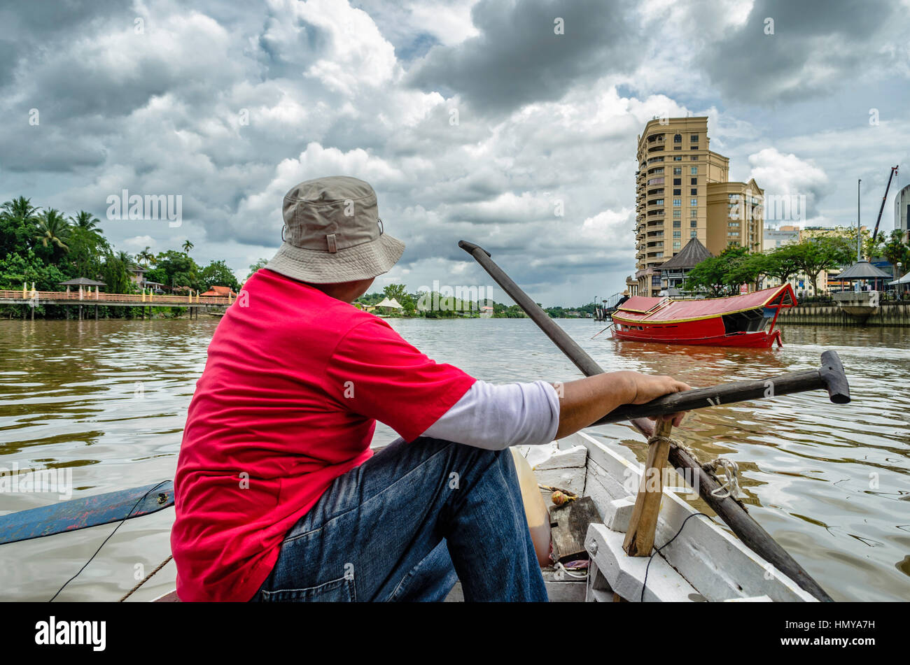 Man cruising down the river on a boat Stock Photo - Alamy