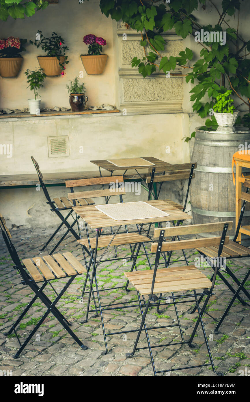 Cozy tables sidewalk cafe Stock Photo - Alamy