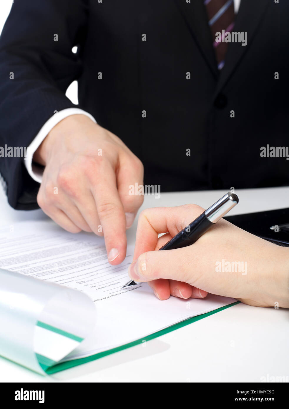 The customer is signing a document on Stock Photo - Alamy